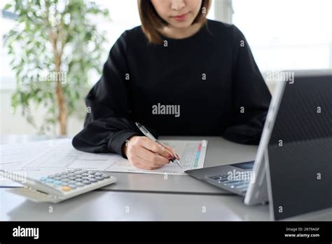 Asian Woman Preparing Tax Return Documents Stock Photo Alamy