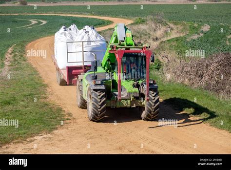 Telehandler Vehicle With Trailer Carrying Bags Of Nitrate Fertiliser