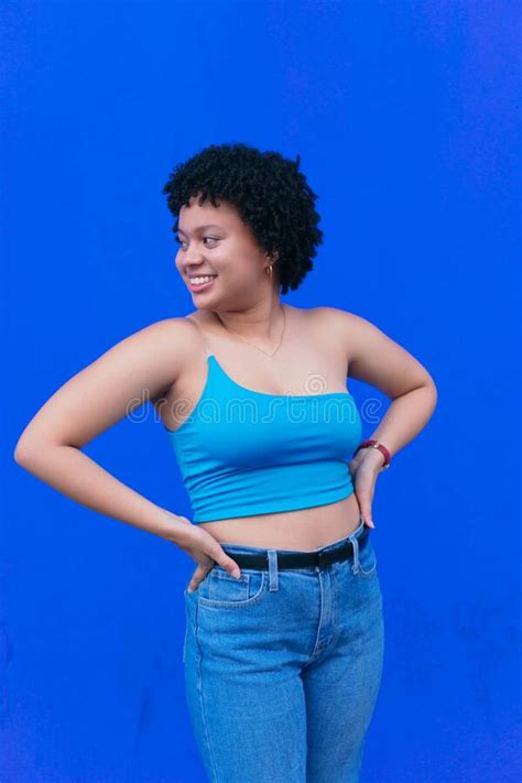 Portrait Of Stylish Young Woman Standing With Her Hands On Her Hips