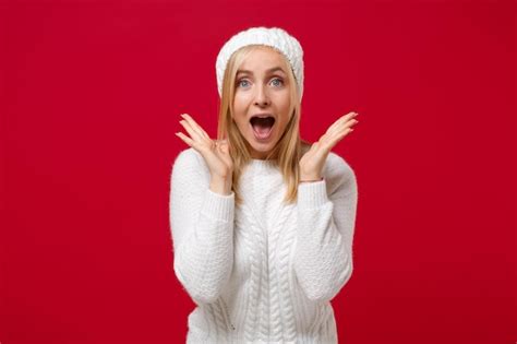 Premium Photo Amazed Young Woman In White Sweater Hat Isolated On