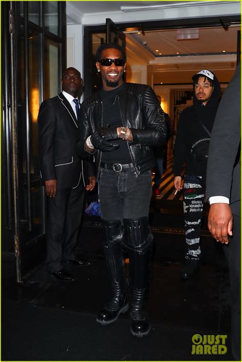 cardi b wears heelless shoes while matching in futuristic outfits with