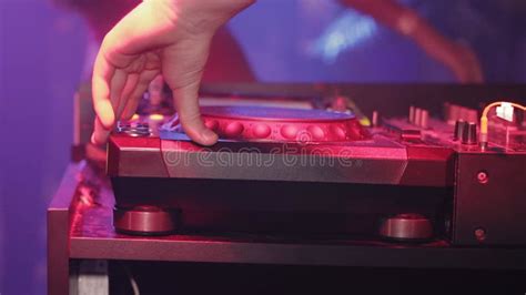 A Dj Presses Buttons On A Professional Music Control Panel In A