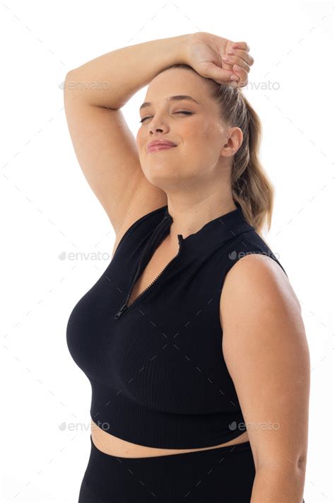 Plus Size Caucasian Female Model Stretches Arm Behind Head On White