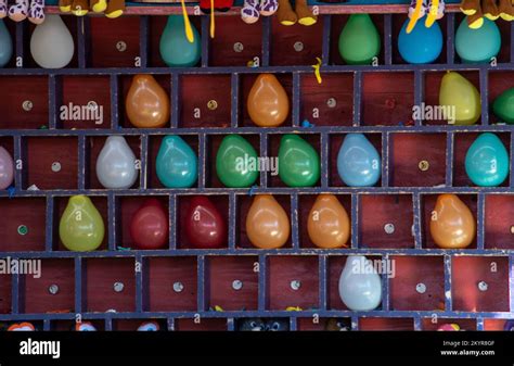 Pop A Balloon With A Dart And Win A Prize At This Carnival Game Both
