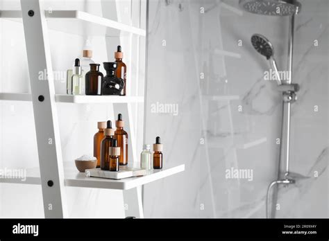 Essential Oils Sea Salt And Other Cosmetic Products On White Shelving