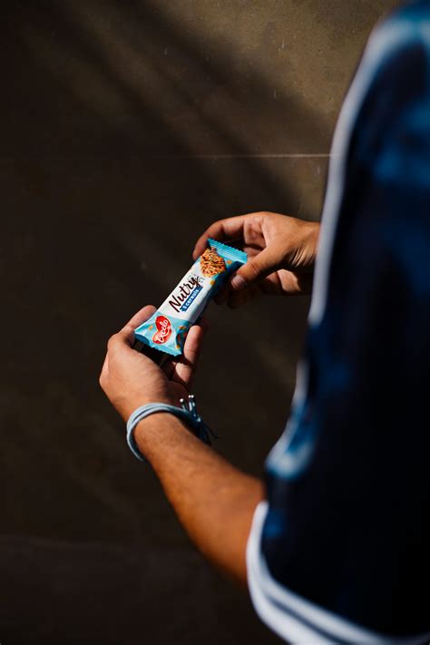 A Man Holding A Tube Of Toothpaste In His Hand Photo Free Image On Unsplash