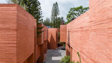 Perforations Characterise Coloured Concrete Housing Block In Mexico City