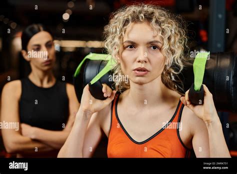 Focus On Blonde Attractive Woman Exercising With Power Bag With Her