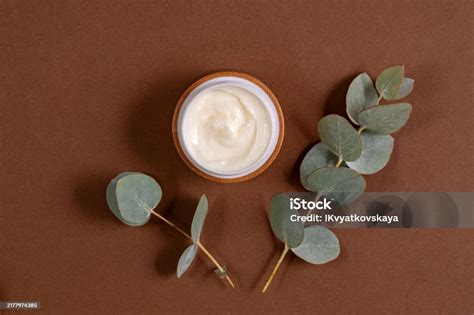 갈색 배경에 얼굴 크림을 가진 대나무 항아리의 평면도 건조 유칼립투스 잎 장식 얼굴과 몸 처리를 위한 직업적인 병 브랜드가 없는 패키지 0명에 대한 스톡 사진 및 기타