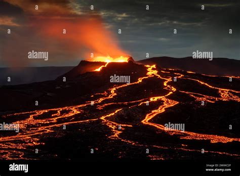 Lava Spurting Out Of Crater And Reddish Illuminated Smoke Cloud Lava