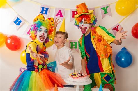 Premium Photo Happy Clowns At The Holiday Blow Out The Candles On The