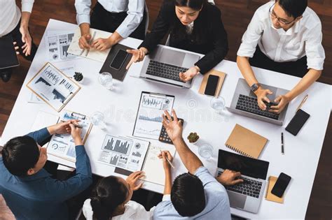 Analyst Team Utilizing Bi Fintech To Analyze Financial Data At Table