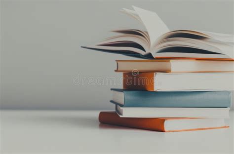 Floating Book Above Stack With Coffee Cup And Decorative Flowers In