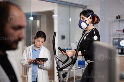 Athlete Woman With Medical Electrodes Working At Body Endurance Running On Gym Bycle In Clinical