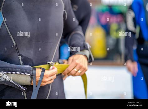 Woman Wearing Scuba Diving Weights Before Going Underwater Spain Stock
