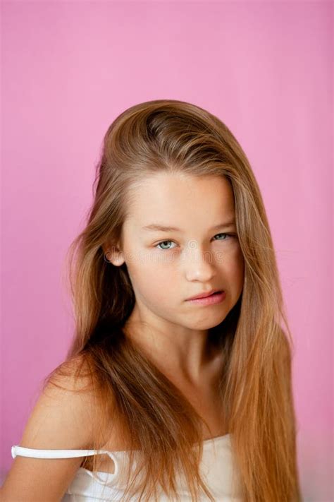Portrait Of A Gentle 9 Year Old Long Haired Girl In A Light T Shirt
