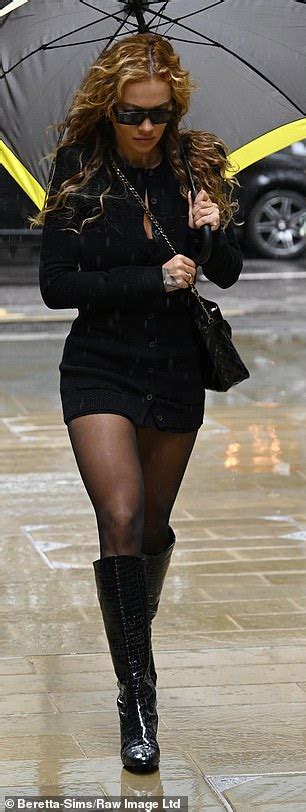 Rita Ora Puts On A Leggy Display In A Lbd As She Shelters From The Rain