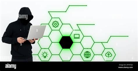 male programmer in black hoodie stands and holds laptop hacker with