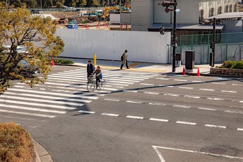 City Street Intersection With Pedestrians Crossing And A Cyclist Under