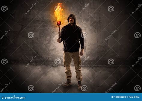 Wayfarer With Burning Torch In Front Of Crumbly Wall Concept Stock