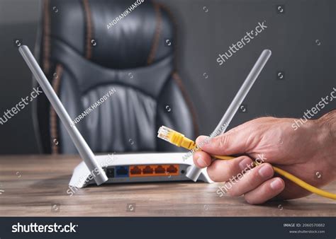 Man Plugging Internet Cable Into Wifi Stock Photo Shutterstock