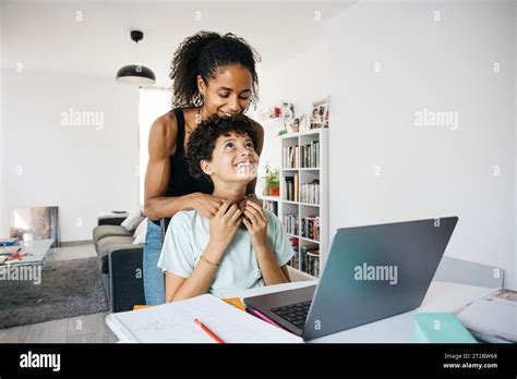 Cheerful Woman Helping Daughter Doing Homework Happy Mother Assisting