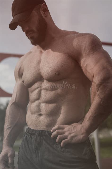 Handsome Strong Young Man With Beard Wearing Black Cap With Perfect