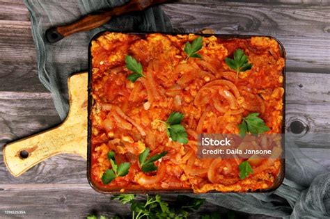 토마토 소스와 양파를 유리 그릇에 넣고 구운 청어 생선을 반죽합니다 토마토 소스에 야채와 함께 구운 생선 0명에 대한 스톡 사진