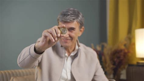 Old Man Holding Bitcoin And Showing It Stock Video At Vecteezy