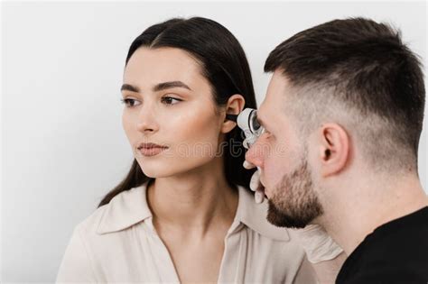 Close Up Examination Of Womans Ear With Otoscope Otoscopy Visit To