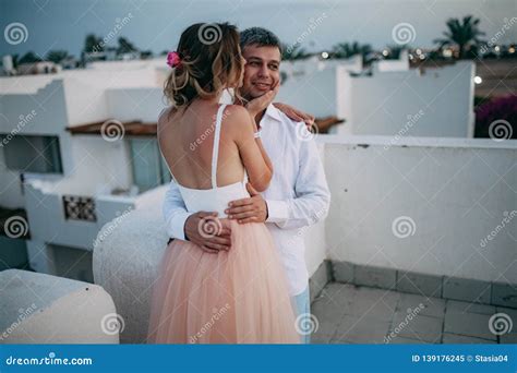 Happy Newlyweds Hug On Roof Of House During The Honeymoon Stock Image Image Of Long Kissing