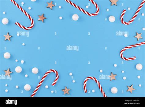 Christmas Flat Lay With Candy Canes Stars And Snowballs On Blue