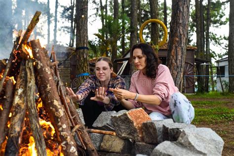 Mother With Her Daughters Spending Time Together Kindle A Fire And