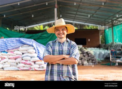 Asian Man Farmer Agriculturist Happy At A Fertilizer Composting Plant