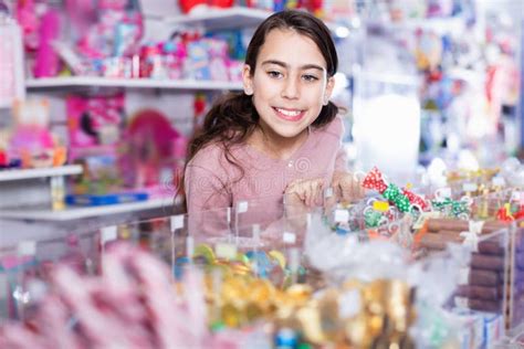 Emotional Small Girl Choosing Sweet Candies In The Candy Shop Stock