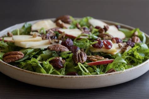 Fall Salad With Arugula Apples Cranberries And Pecans Closeup