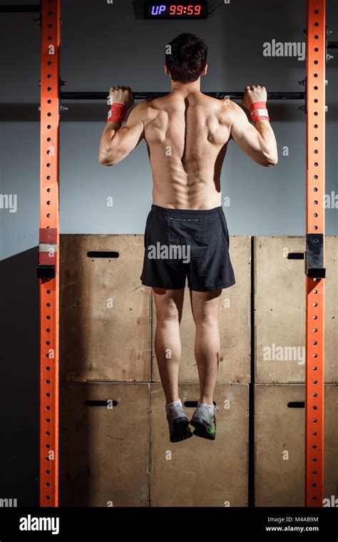 Fitness Toes To Bar Man Pull Ups Bars Workout Exercise At Gym Stock
