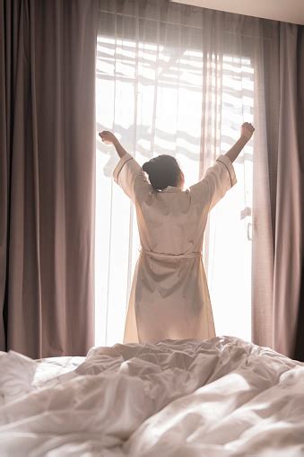 흰색 드레스 아시아 여성 아름다운 여자 스트레칭 아침 은 흰색 커튼과 태양 빛 배경 라이프 스타일 홈 개념과 아늑한 인테리어 침실에서 신선함과 평온한 주말 순간을 깨워