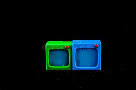 Two Small Televisions Are Shown Side By Side One Green And One Blue