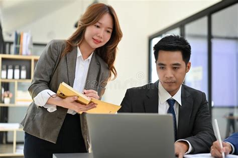 Attractive Young Asian Female Secretary Or Assistant Working With Her