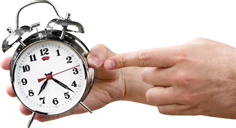 Premium Photo Man Holding Alarm Clock Isolated On White Background