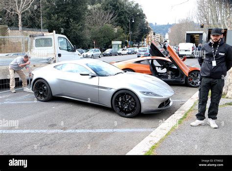 An Aston Martin Db10 And Jaguar X75 Parked On The Banks Of The Tiber