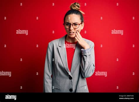 Young Beautiful Blonde Businesswoman With Blue Eyes Wearing Glasses And