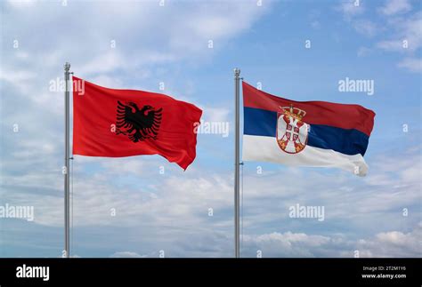 Republic Of Serbia And Albania Flags Waving Together In The Wind On
