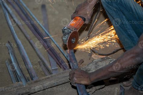 Close Up Of Busy Welder In Apron Rough Grinding Metal Piece With Rotary