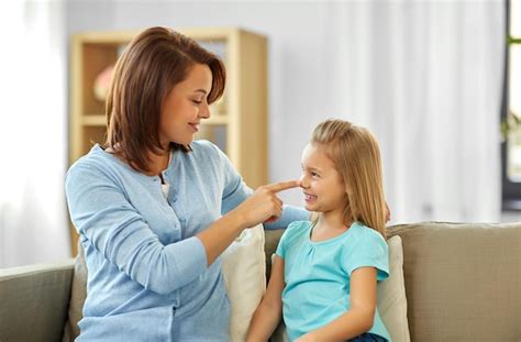 Premium Photo Mother And Daughter Sitting On Sofa At Home