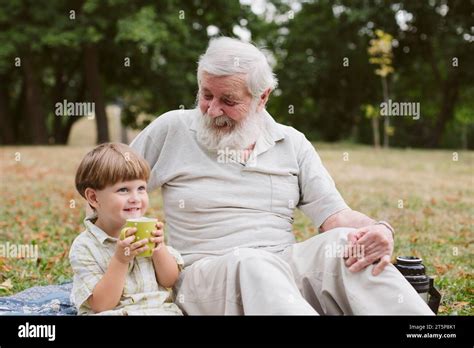 Grandson With Grandpa Drinking Tea Stock Photo Alamy