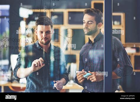 Problem Solving Like Pros Two Young Businessmen Brainstorming On A