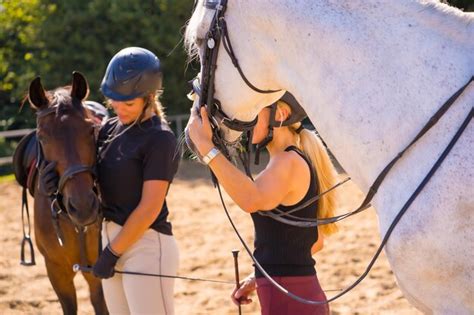 Premium Photo Caucasian Blonde Girl Stroking A White Horse On A