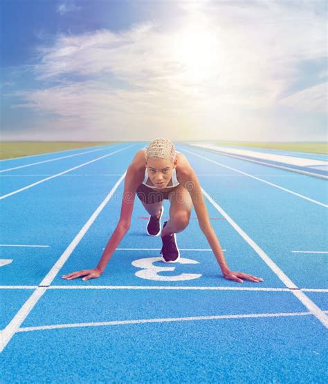 An African American Female Athlete Stands Poised At The Starting Line